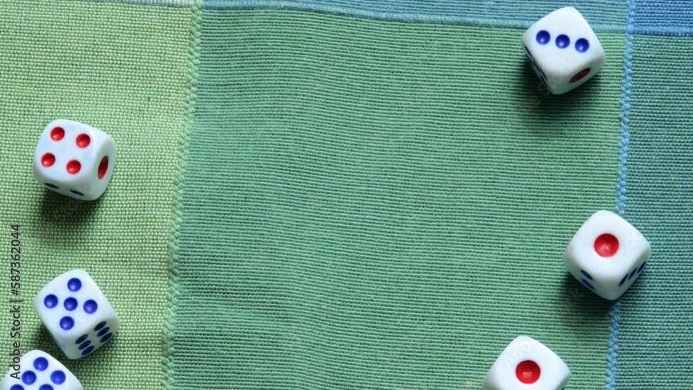 Small game dice being thrown on a table forming an abstract blank empty ...