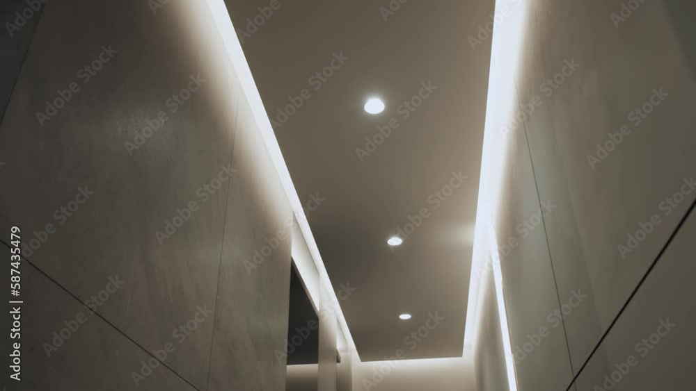 Dolly shot of round modern ceiling lamp in minimalist interior with ...