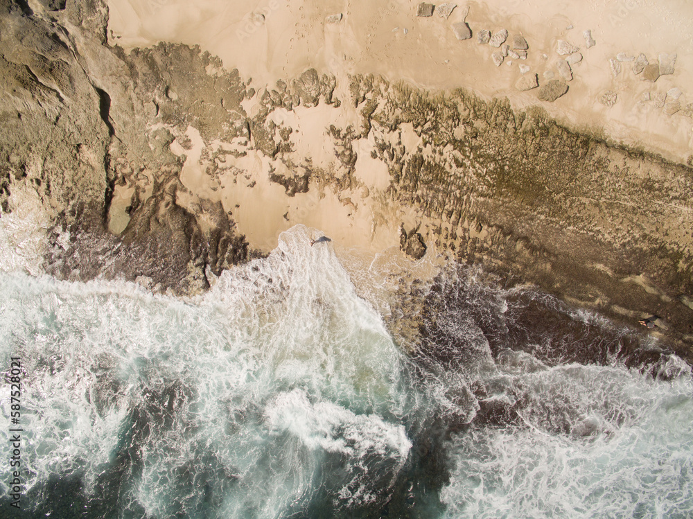 Foto de Sand and rock are being eroded away with each wave that crashes ...