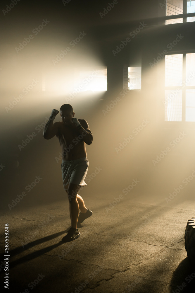 Lightweight fighter training inside the gym. Male boxer athlete ...