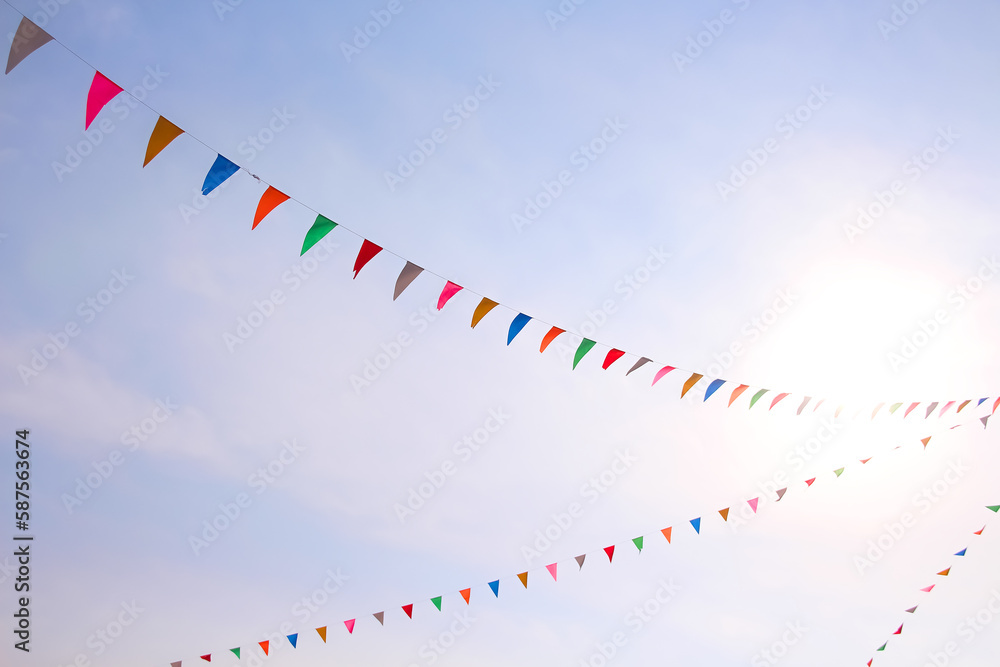 Flags paper hang on white string line and pole on bright blue sky ...