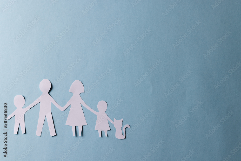 White paper cut out of family with two children and cat and copy space ...