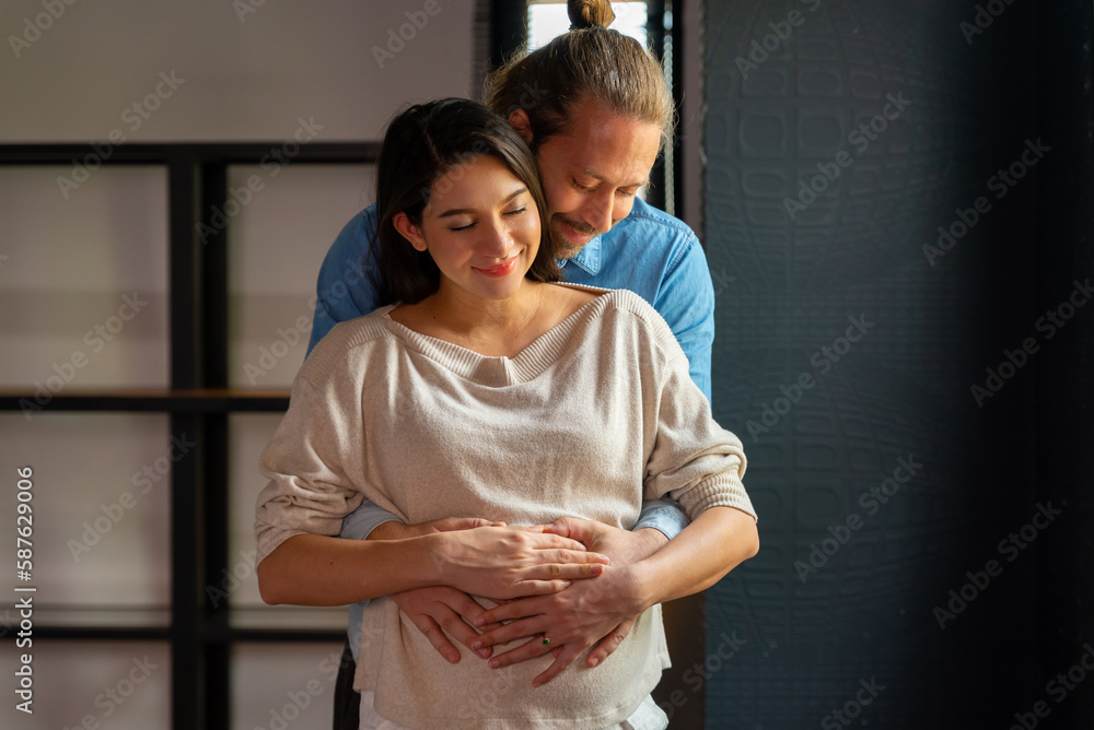 Happy Caucasian pregnancy woman and husband hugging each other and ...