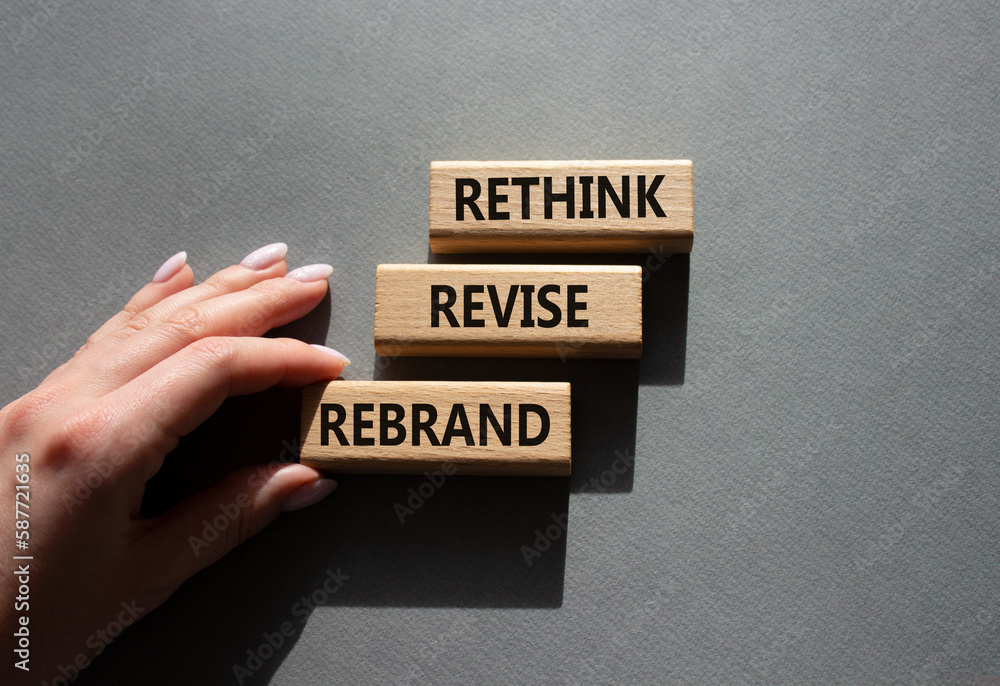 Rethink Revise Rebrand symbol. Wooden blocks with words Rethink Revise Rebrand. Beautiful grey ...