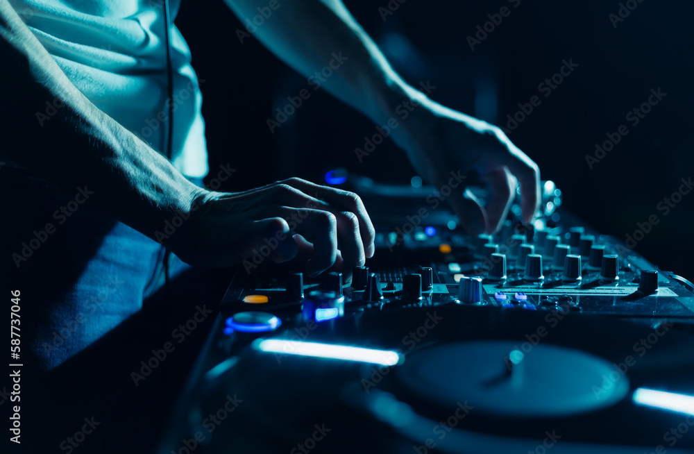 Techno party DJ playing music with sound mixer and turntables. Club ...