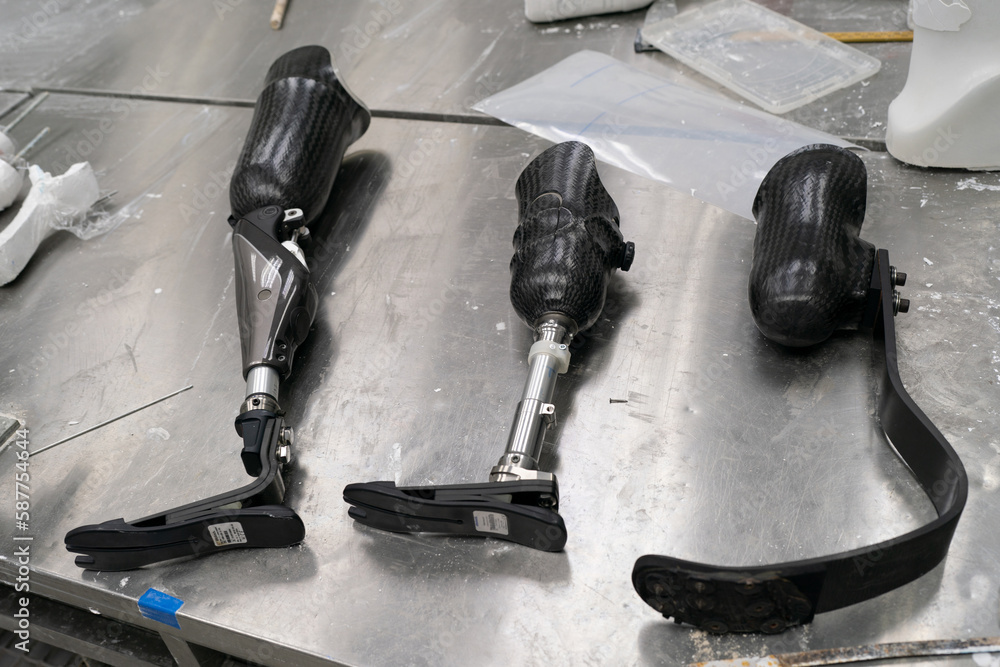 Production of a prosthetic leg. A woman creates part of the leg. An ...