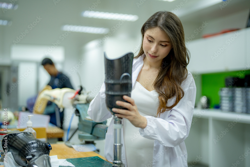 Production of a prosthetic leg. A woman creates part of the leg. An ...