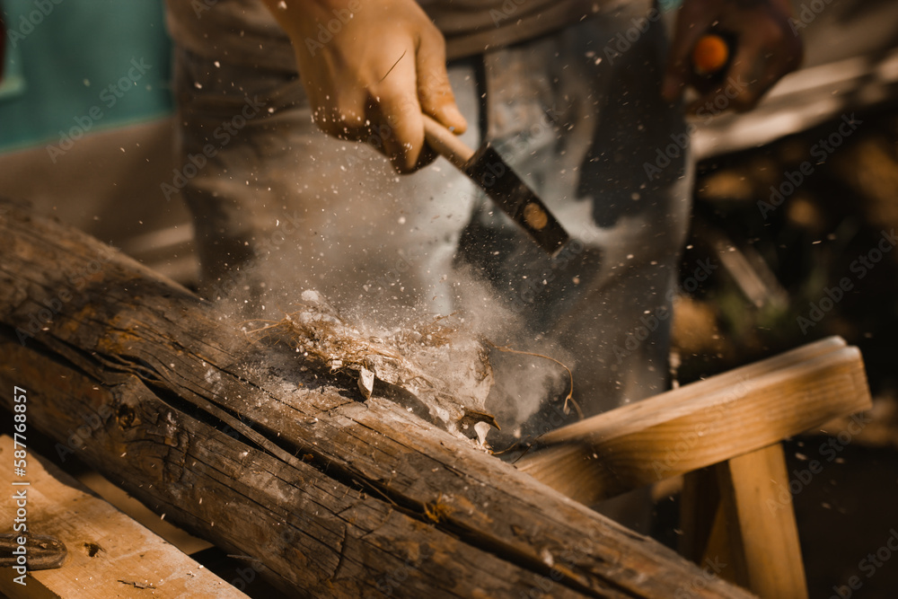 A carpenter man professional master working with a . Slivers of wood ...