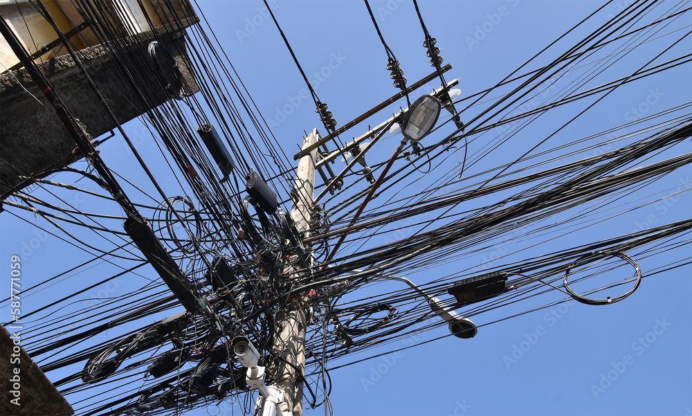 messy electrical wires, communication network cable, telephone line and ...