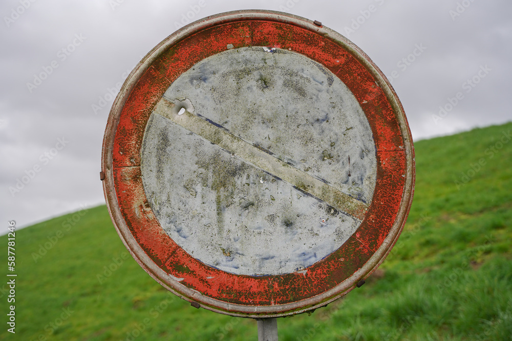 Road sign 'no entry for all vehicles' overgrown with moss and riddled ...
