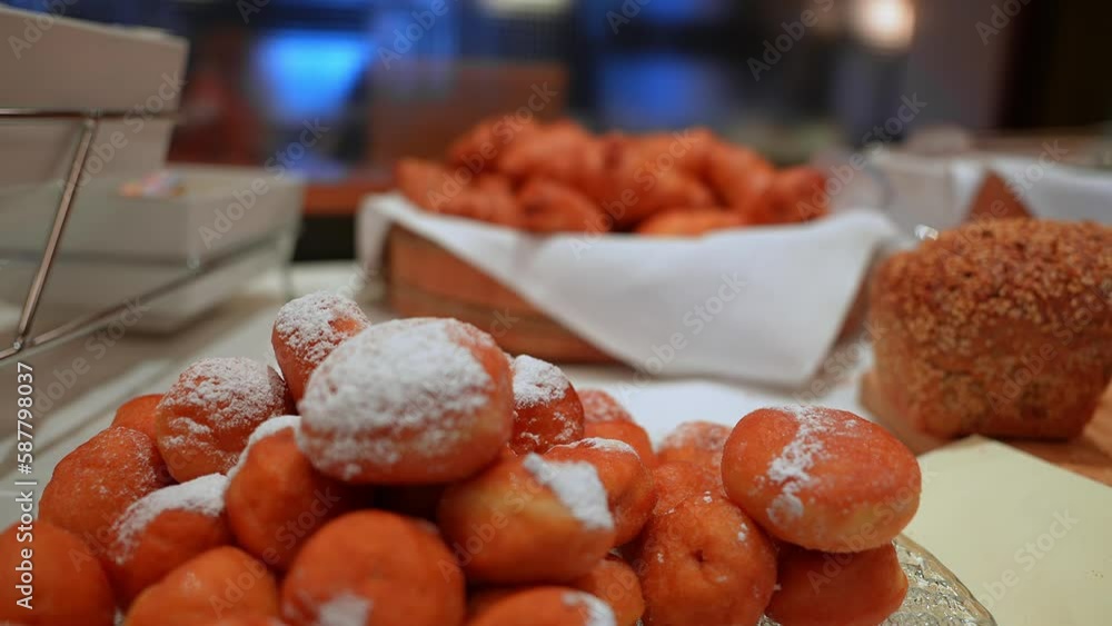 Delicious panoramic view of the buffet table with waffle and donut in a luxury hotel. Closeup of ...
