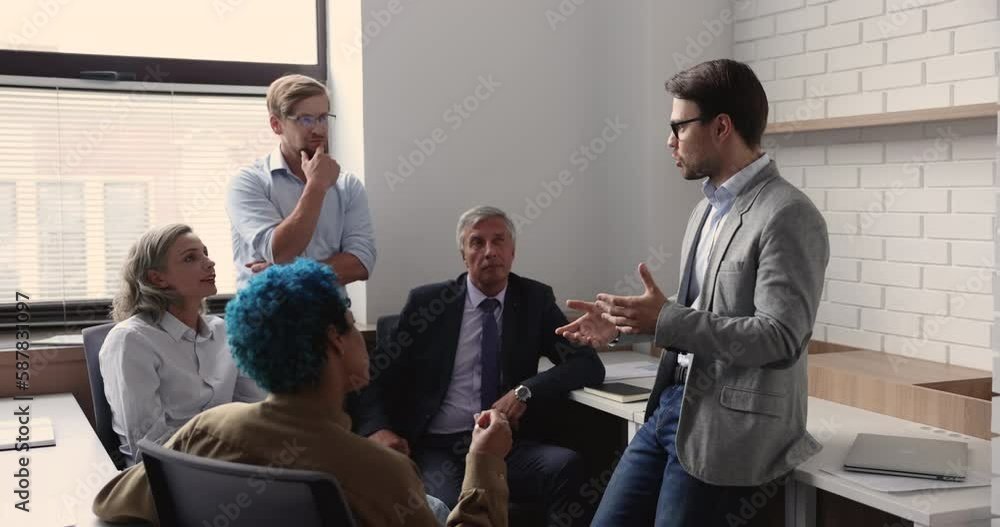 Group of diverse employees solve current issues, listen to team leader ...