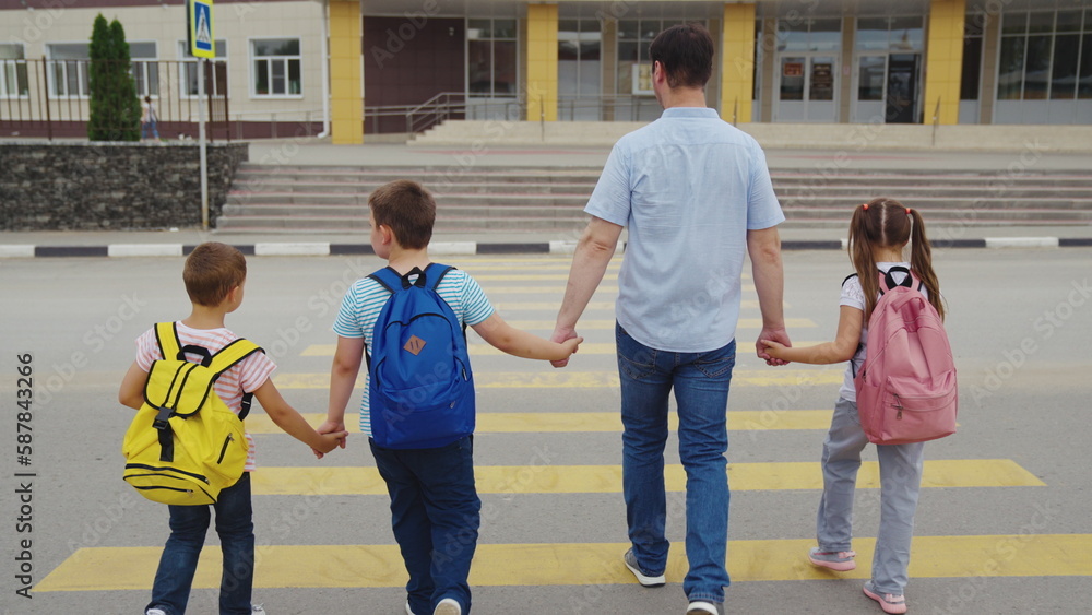 father leads child across road school zebra. hold hand. child boy girl ...