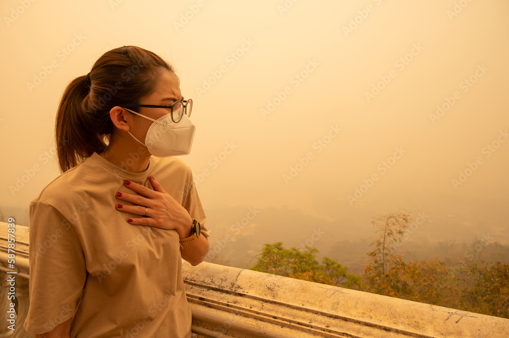 Asian woman having respiratory allergy caused of by Bad air pollution (PM2.5). PM2.5 levels ...