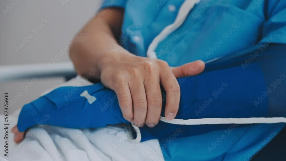 Man with broken arm in cast lying on bed in hospital. The emergency ...