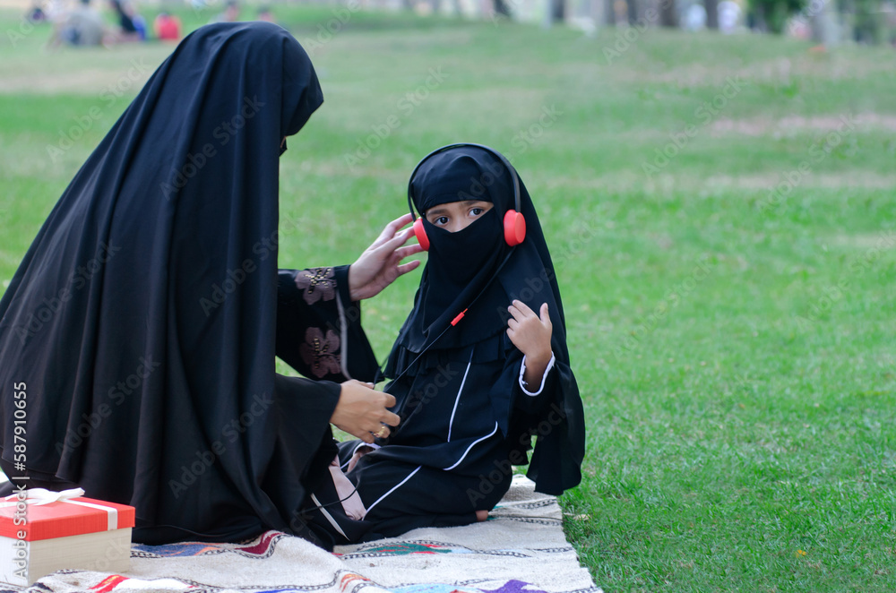 Muslim mother and daughter wearing black niqab spending weekends ...