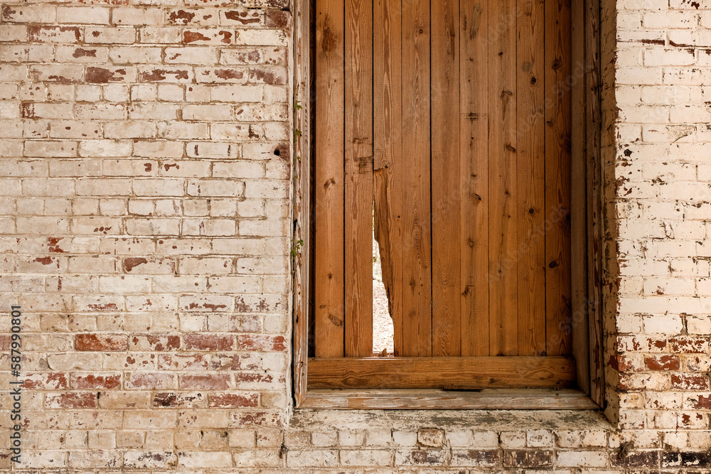 Shuttered window with break in shutter and old white washed brick wall ...