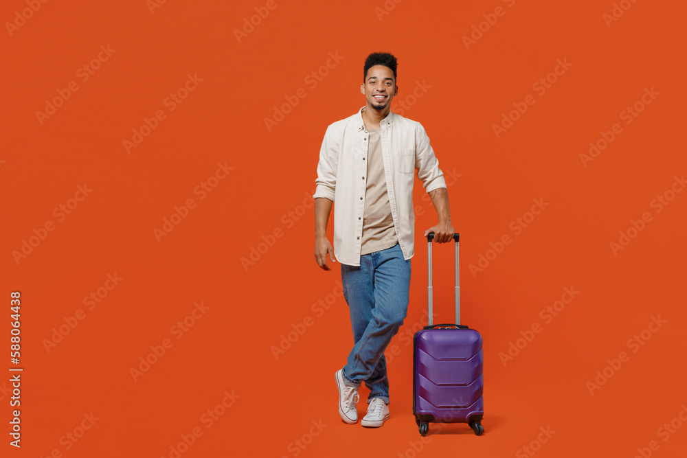 Foto de Full body traveler man wears light casual clothes hold suitcase ...