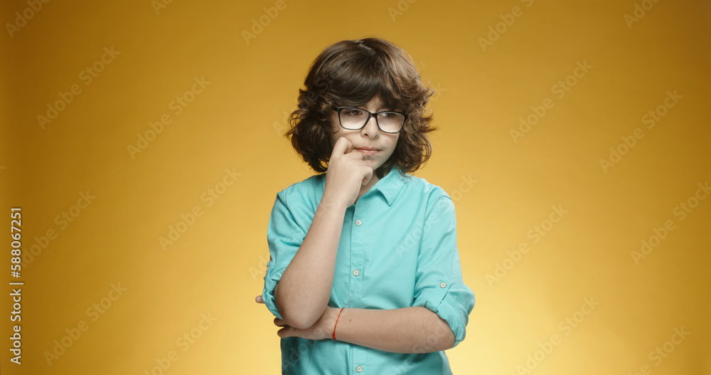 Cute caucasian boy looking down and thinking about something, isolated ...