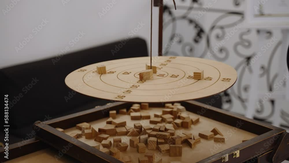 Man in business suit incorrectly plays wooden balance game with himself ...