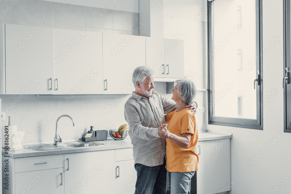 Joyful active old retired romantic couple dancing laughing in living ...