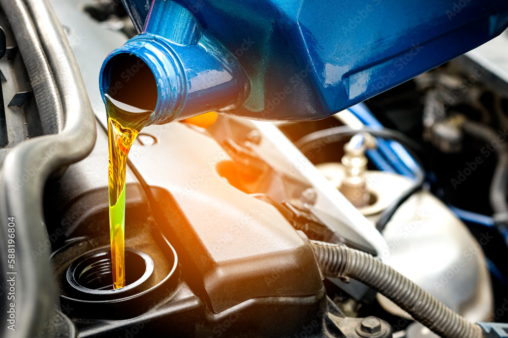 Refueling and pouring oil quality into the engine motor car ...