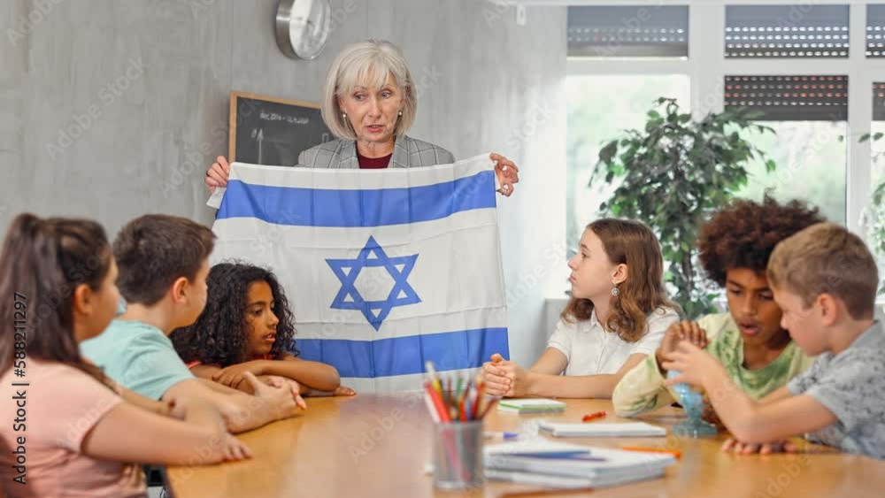 Kids learning together about israel in geography class Female teacher ...