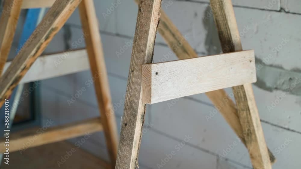 Scaffolding from wooden boards for interior work, close-up. Homemade ...