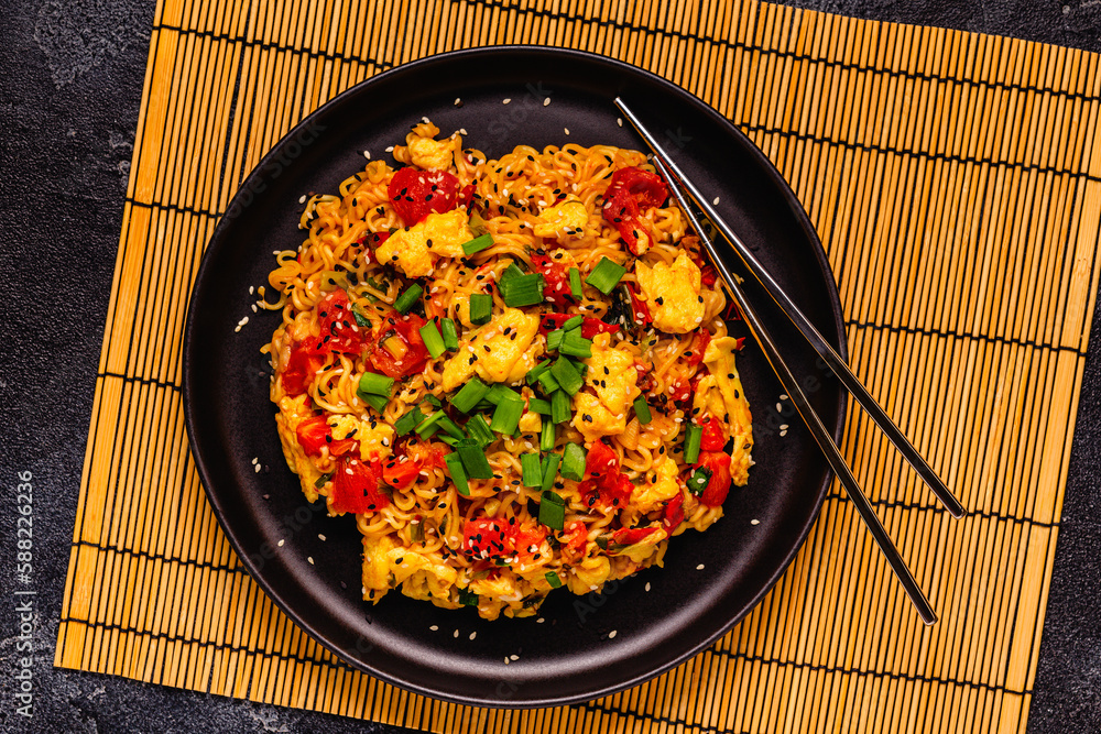 Korean style instant noodle, Shin Ramyeon with tomatoes and scrambled ...