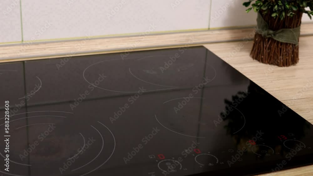 Video of female hand turning on off black induction cooker panel, built ...