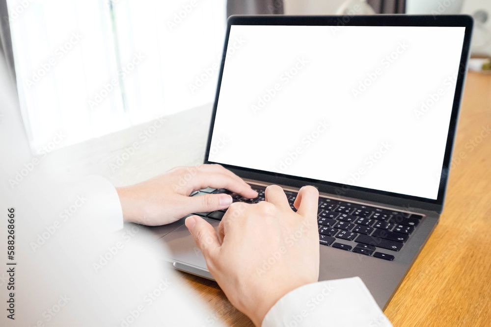 Over shoulder view of woman student elearning looking at white mock up blank screen using laptop ...