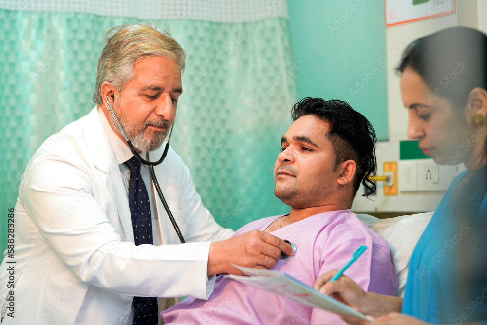 Senior Doctor check up using a stethoscope to patient on bed at ...