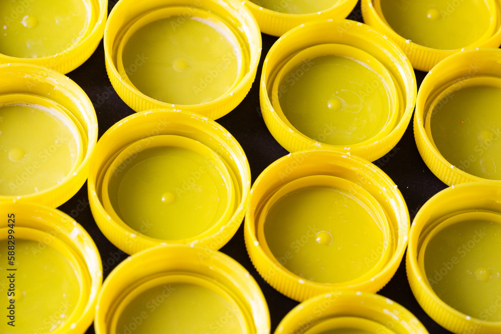Plastic bottle caps background. Collecting bottle caps texture. Yellow ...