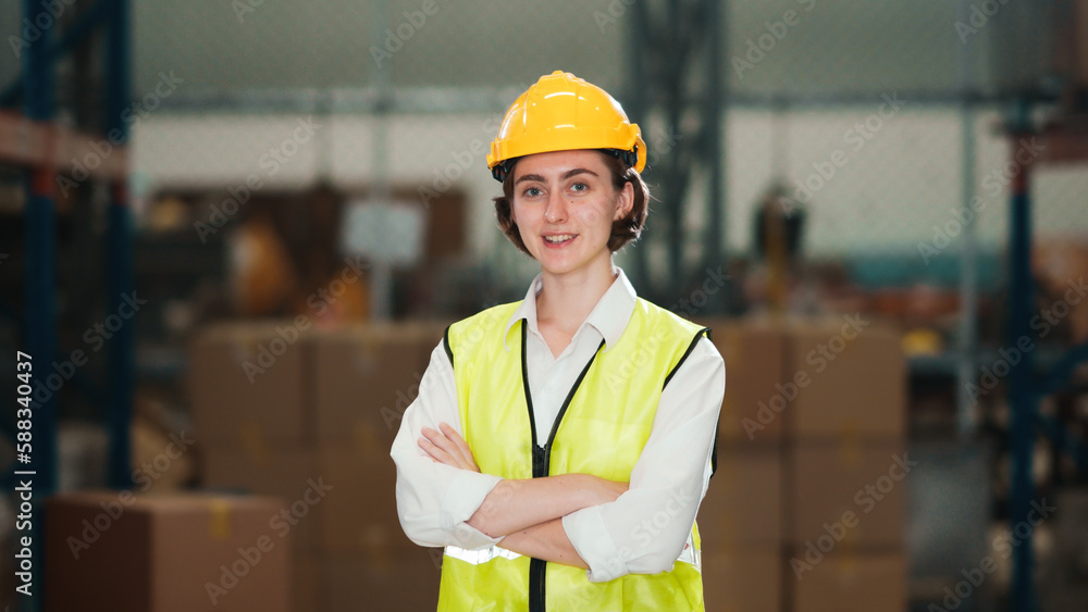 Portrait of Caucasian warehouse worker in safety wear standing and ...