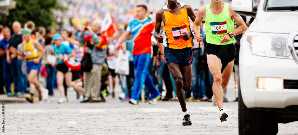 two leading runners kenyan and european running marathon behind an ...