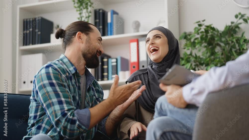 Smiling muslim couple talking during psychotherapist session, couples ...