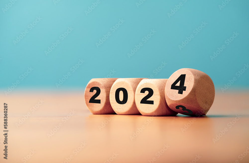 Flipping of 2023 to 2024 on wooden block cube for preparation new year ...
