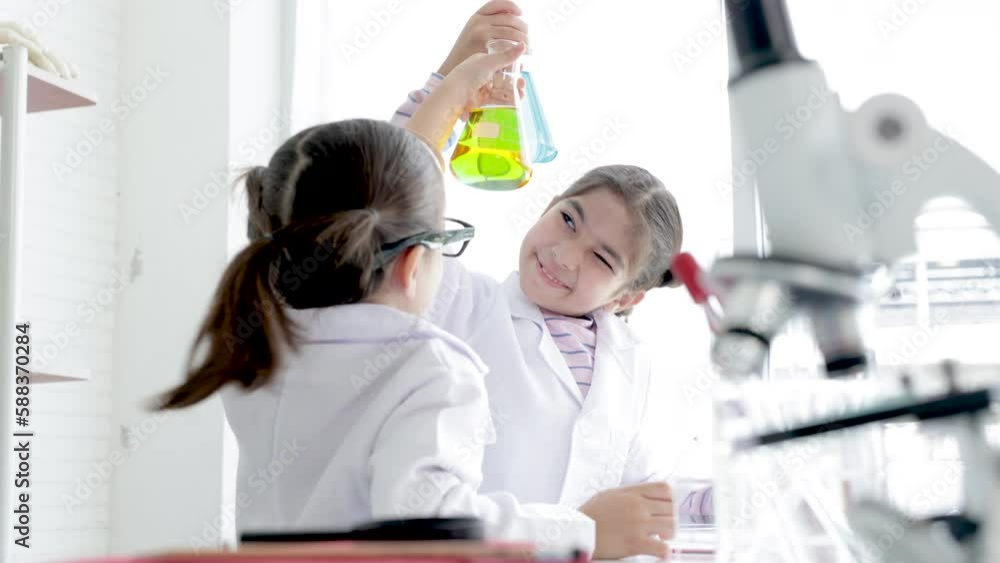 Adorable caucasian young kids having fun in science chemistry class in ...