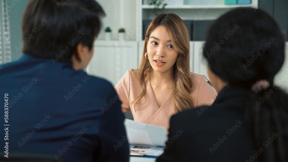 A young female asian candidate tries to impress her interviewer by ...