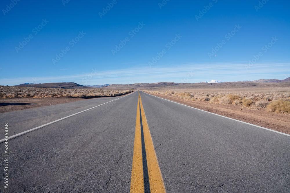 The open stretch of desert highway showing a double yellow line Stock ...