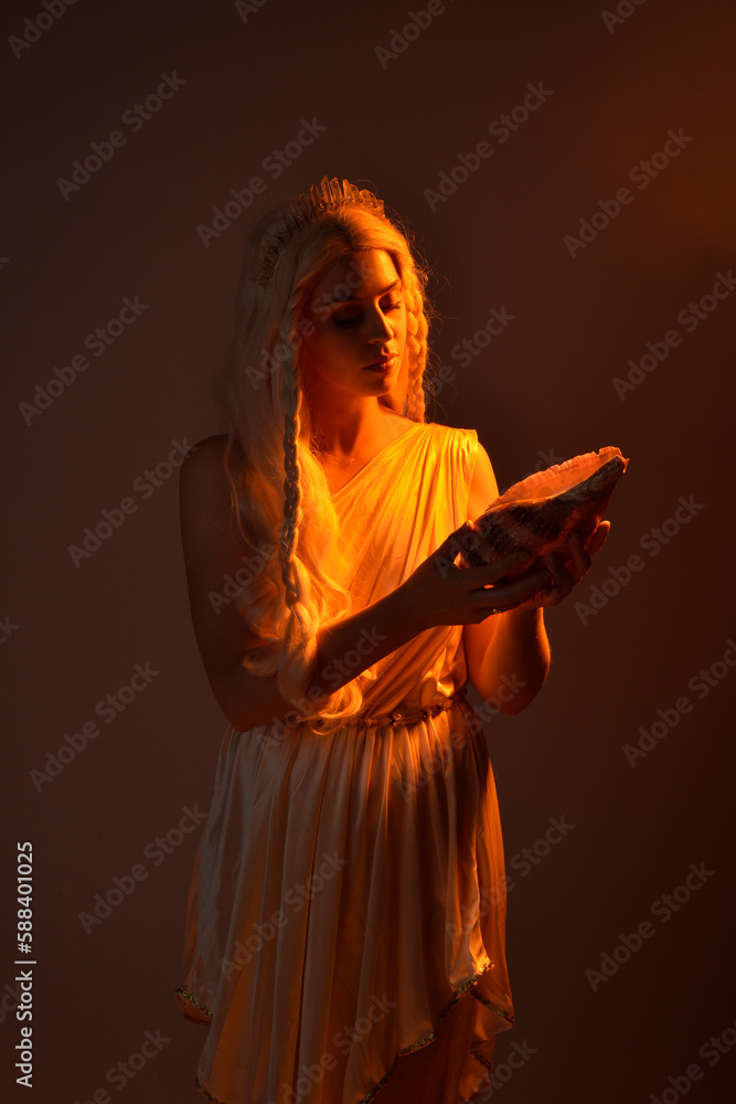 portrait of beautiful blonde woman wearing a fantasy goddess toga ...