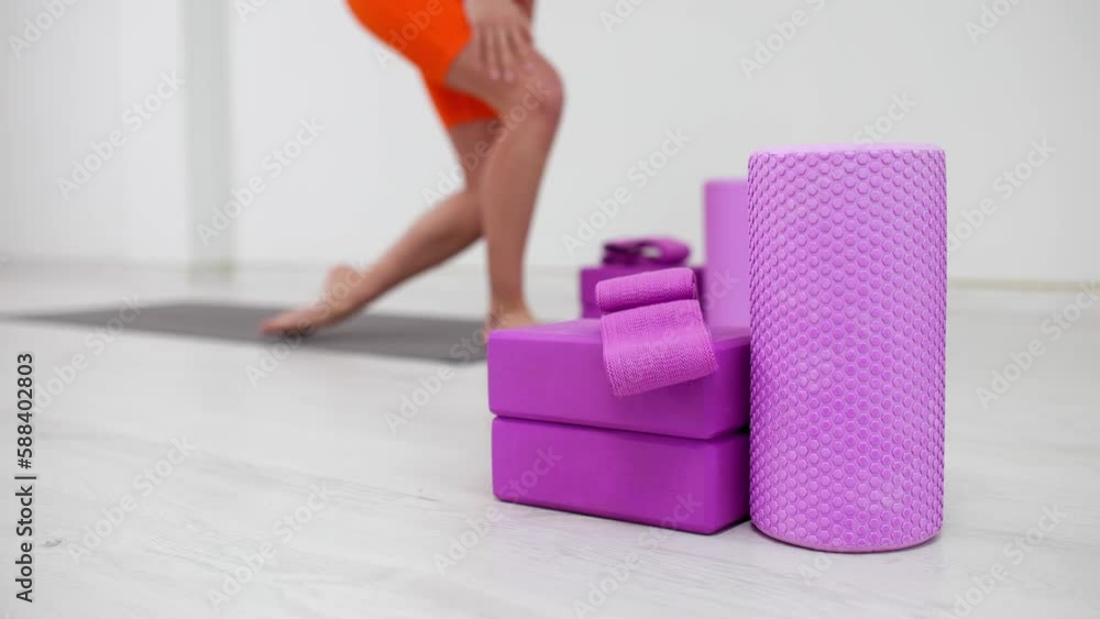 Fitness girl with expander doing leg exercises, floor exercises with ...