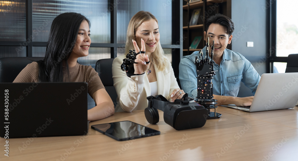 Young male and female working with AI robot arm system project in ...