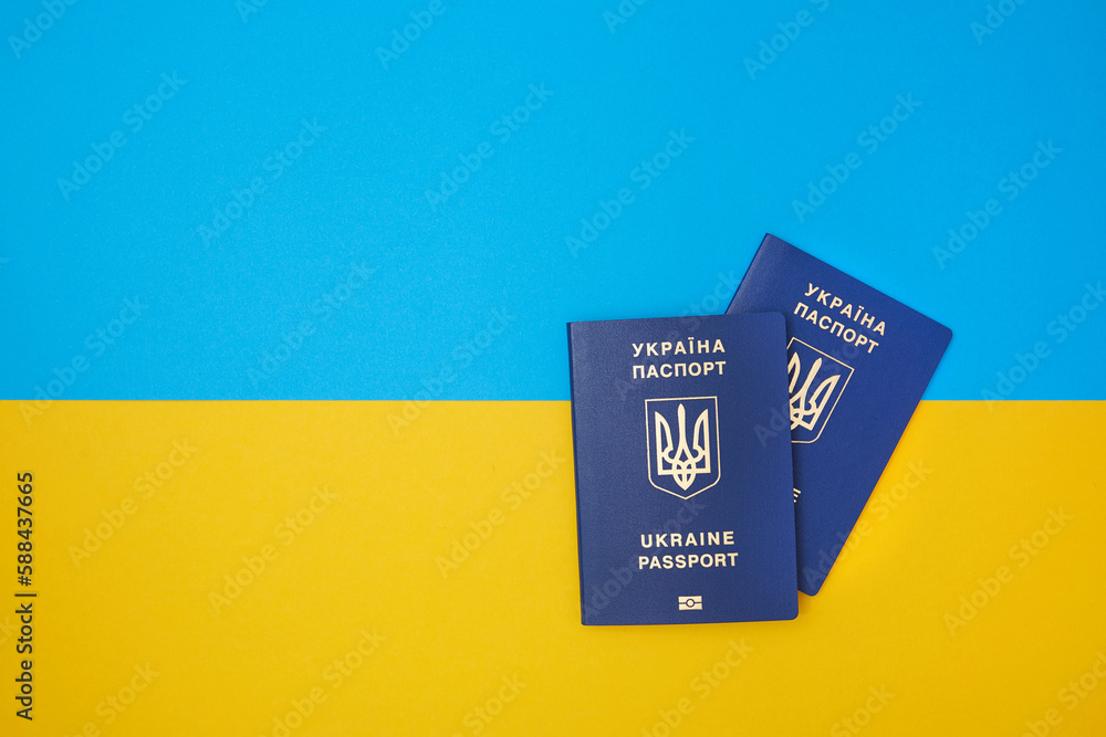 Two blue Ukrainian biometric passports on the Ukrainian national flag ...