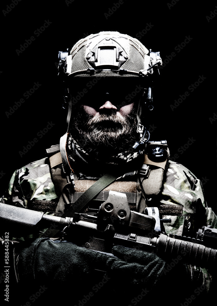 Close up, low key half length portrait of bearded commando fighter ...