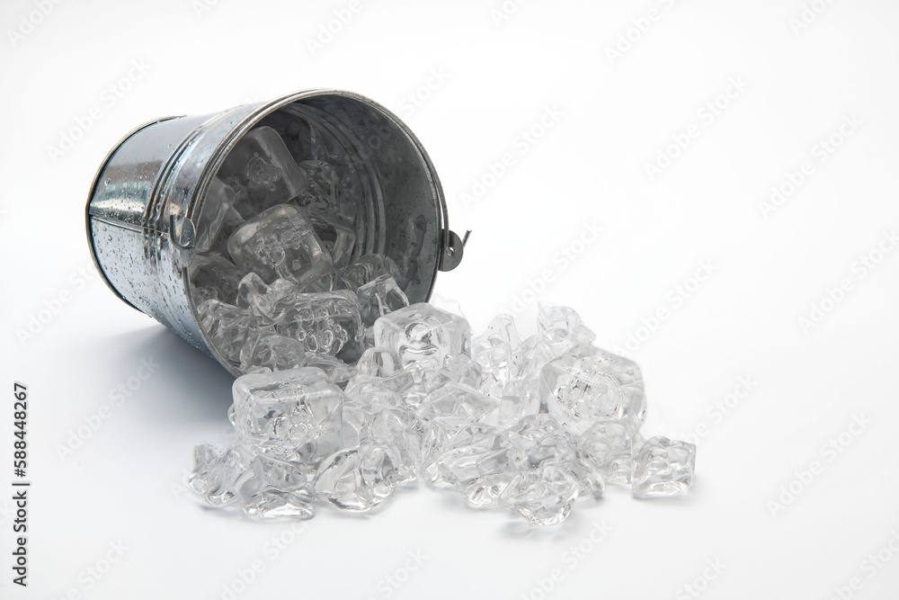ice bucket on its side with spilled ice isolated on a white background ...