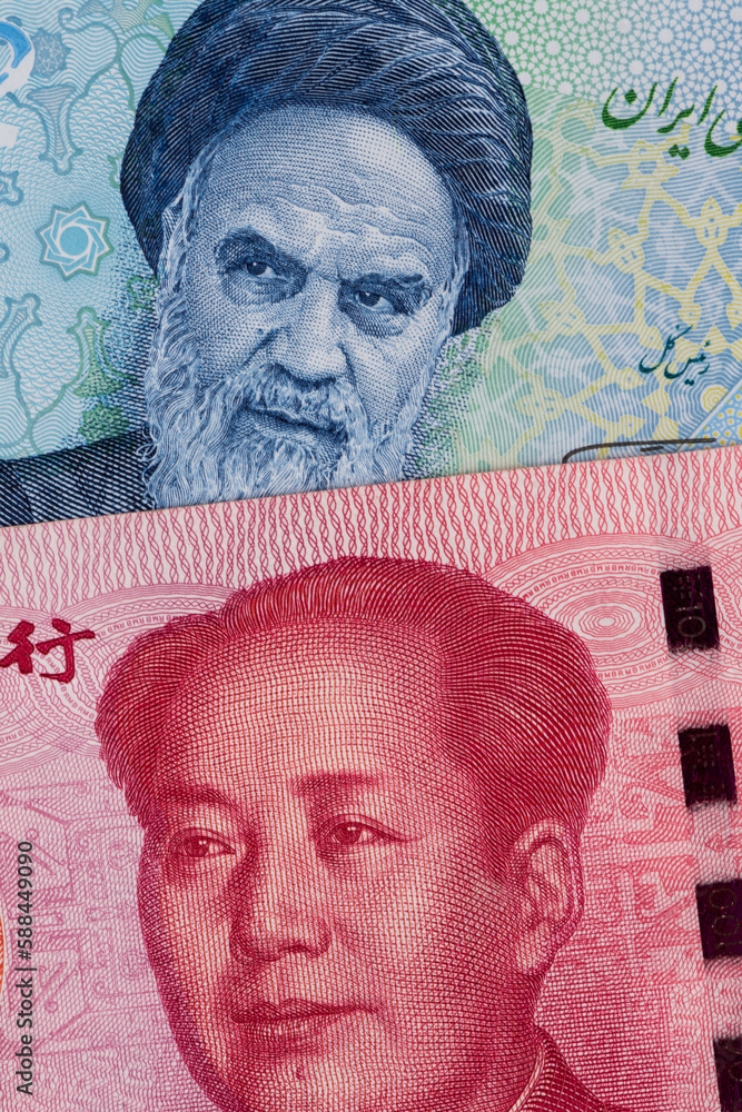Fragments of banknotes of 100 Chinese yuan and 2/2000 Iranian tuman ...