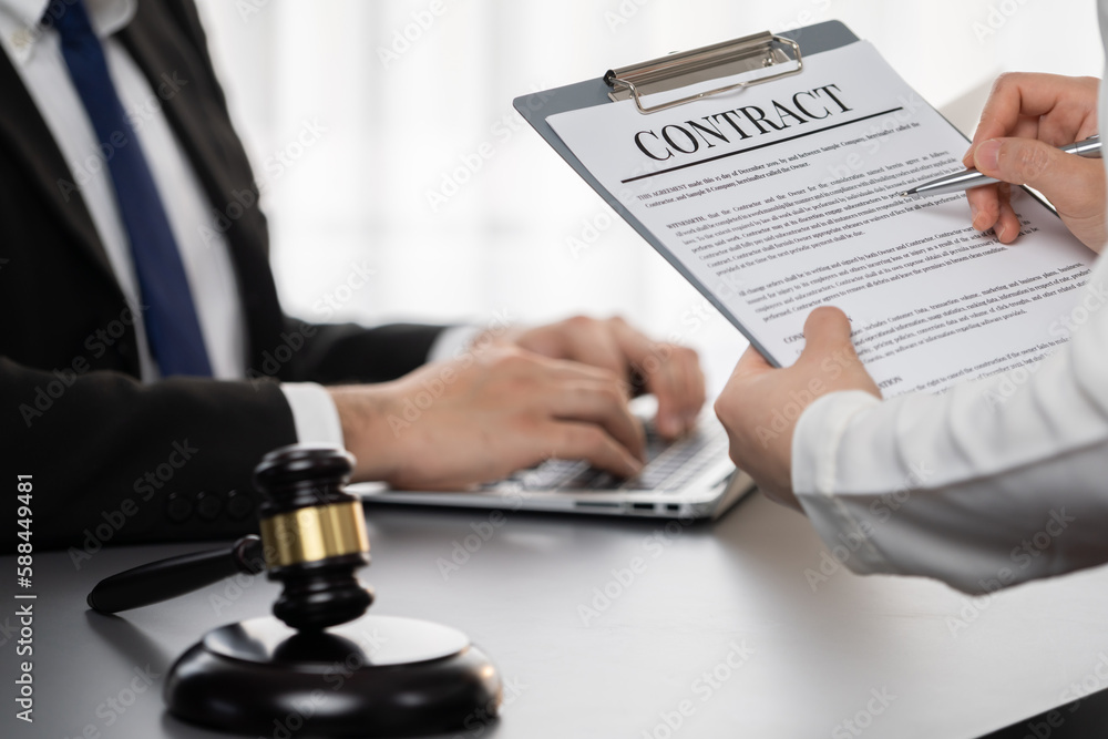 Focus contract paper on blur background of legal team or lawyer ...
