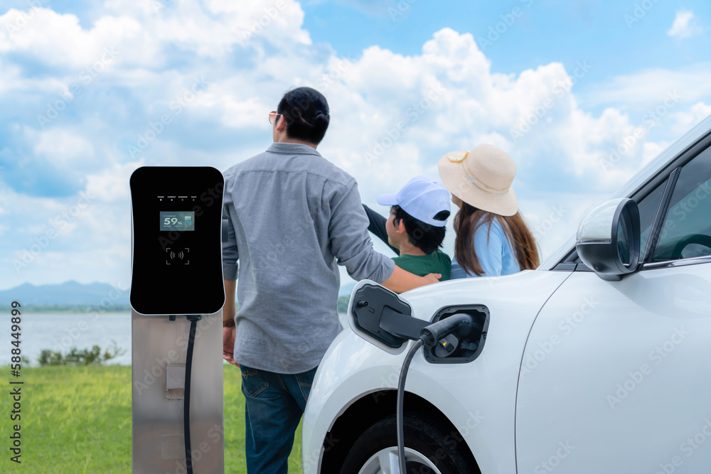 Concept of progressive happy family with electric vehicle enjoy their ...