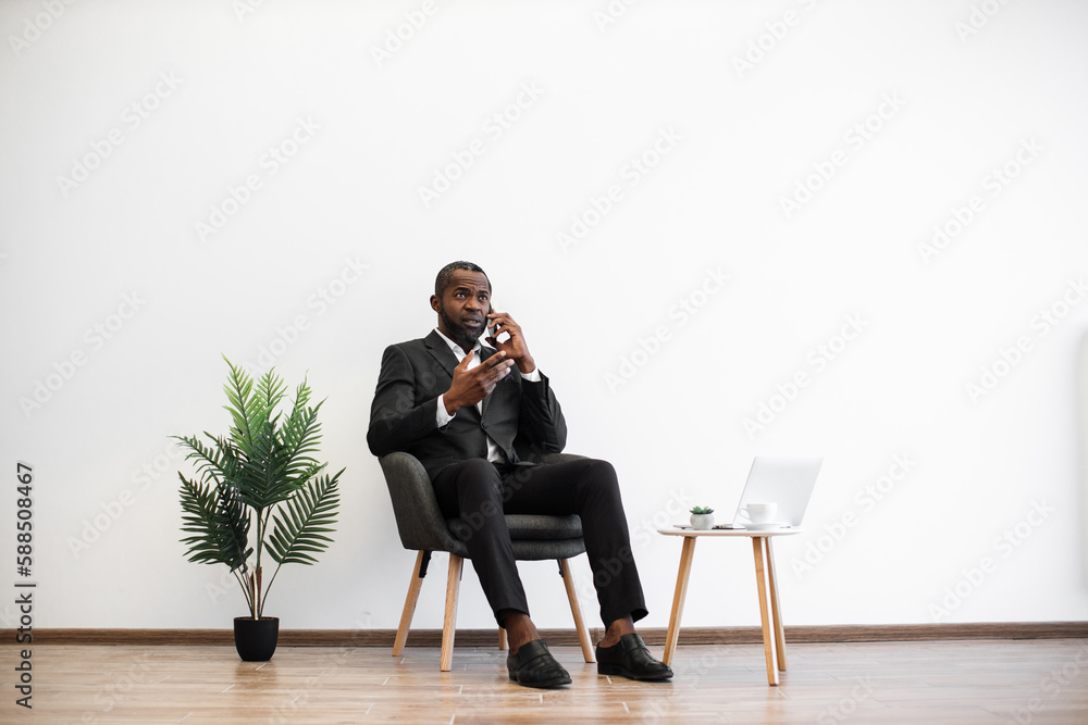 Busy african american man dressed in business suit having intense ...